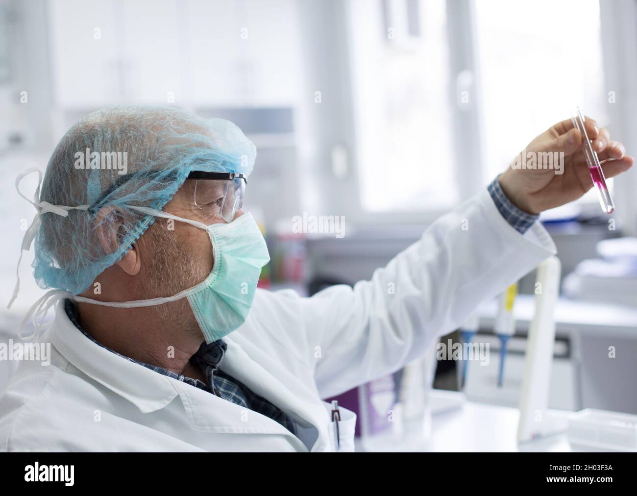 Doctor holding test tube with chemicals in laboratory. Health care and ...
