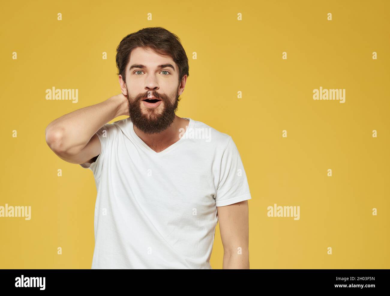 emotional man in a white t-shirt hand gestures anger Studio Stock Photo ...