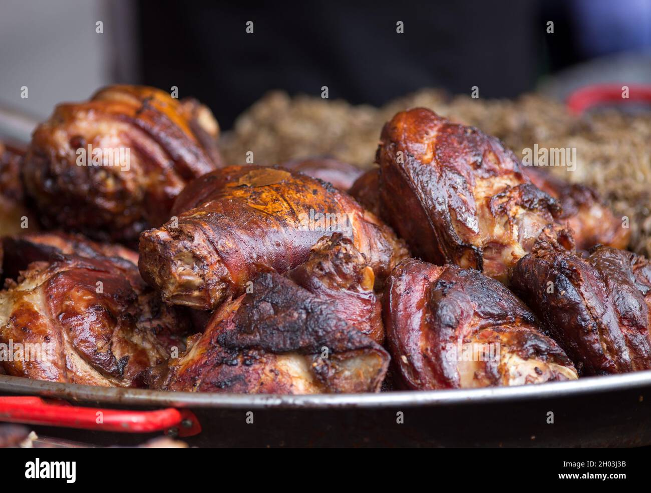 Pile of roasted pork knuckle on metal plate. Traditional balkan fat ...