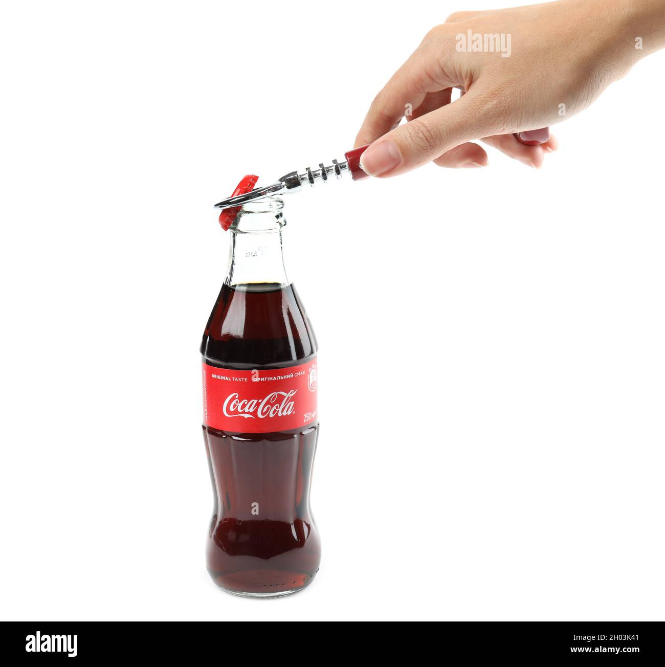 MYKOLAIV, UKRAINE - NOVEMBER 15, 2018: Woman opening Coca Cola bottle ...