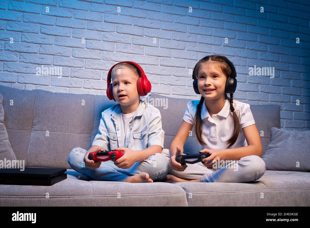 children playing video game with game console Stock Photo - Alamy