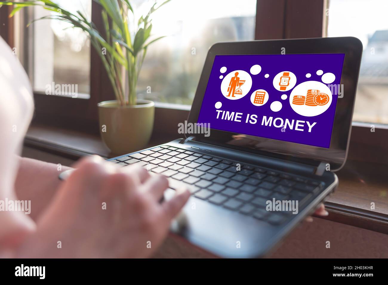 Laptop screen displaying a time is money concept Stock Photo - Alamy