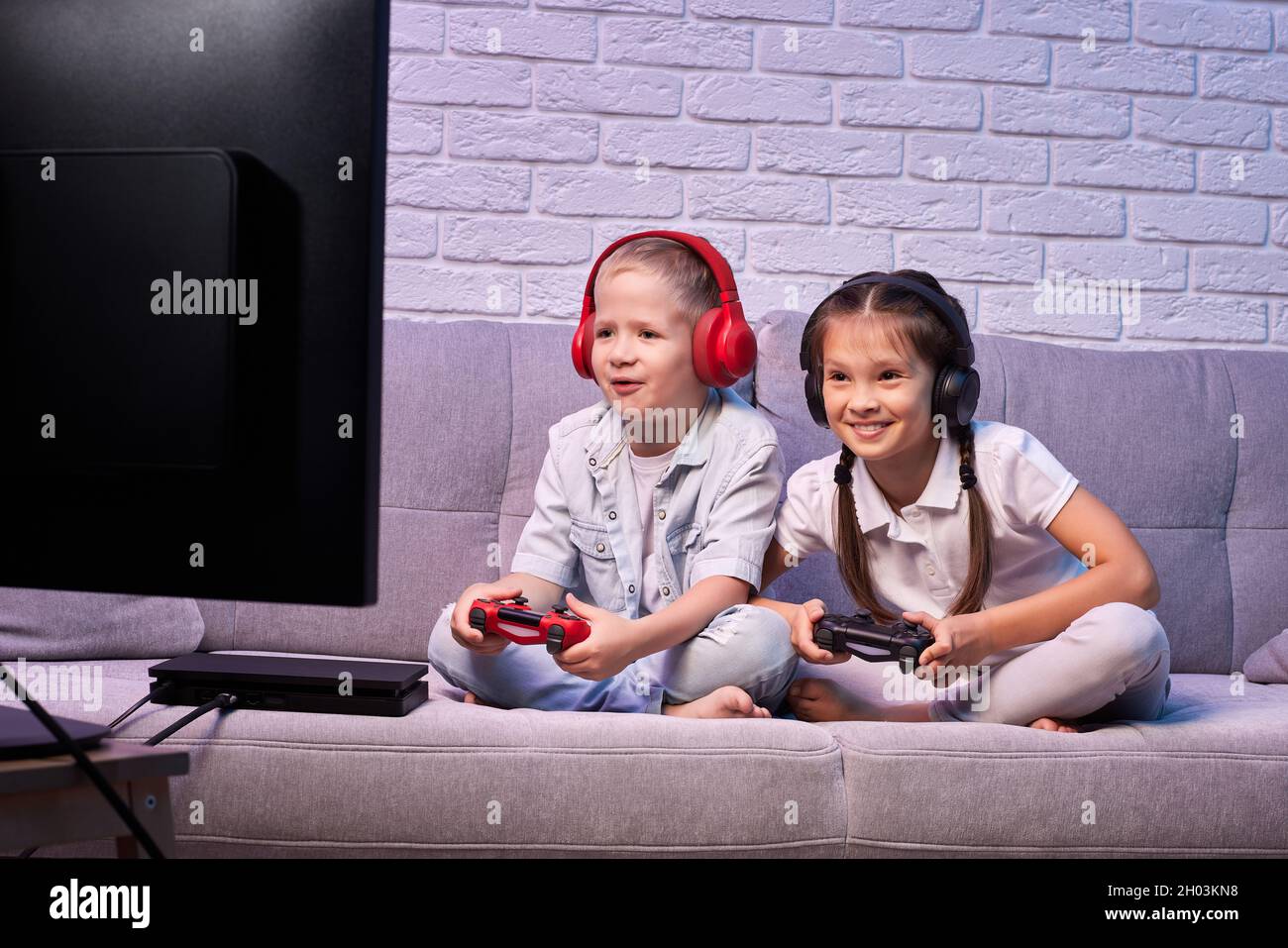 children playing video game with game console Stock Photo - Alamy