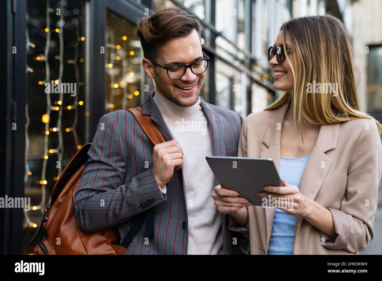 Happy successful business couple having fun, working together outdoors ...