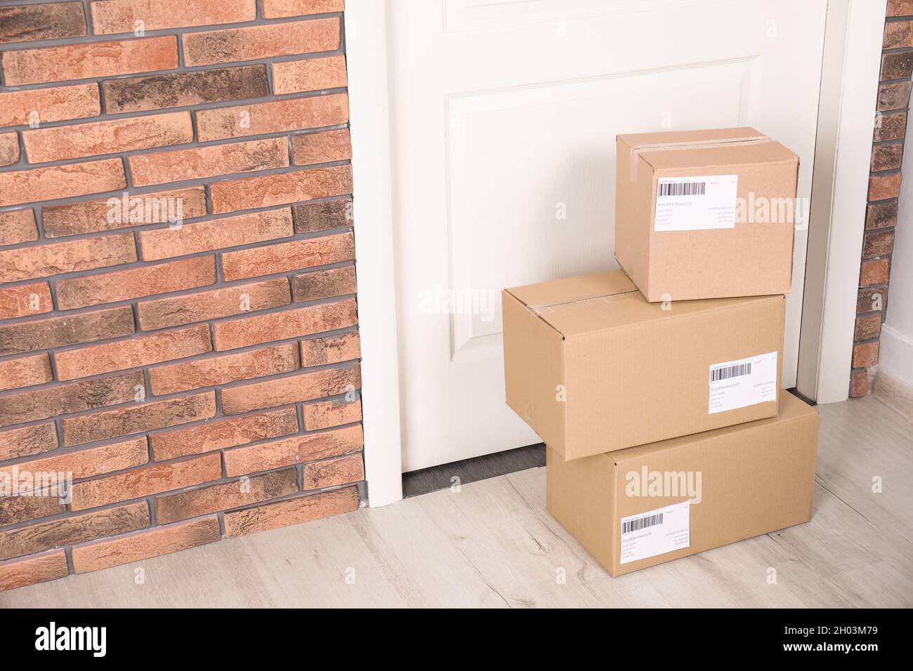 Cardboard parcel boxes on floor near apartment entrance. Mockup for ...