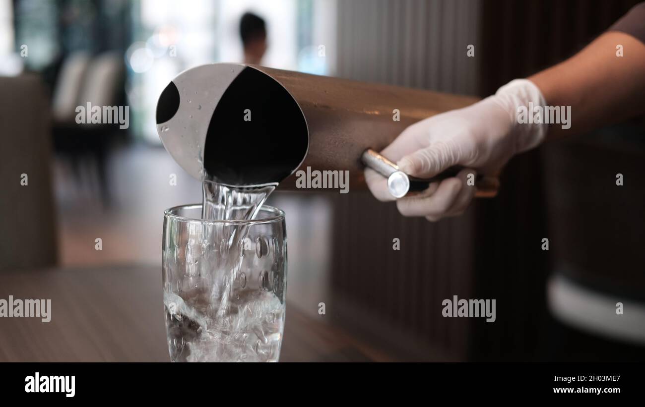 Cool Runnings Water Being Hand Poured Into a Glass of Ice Stock Photo ...