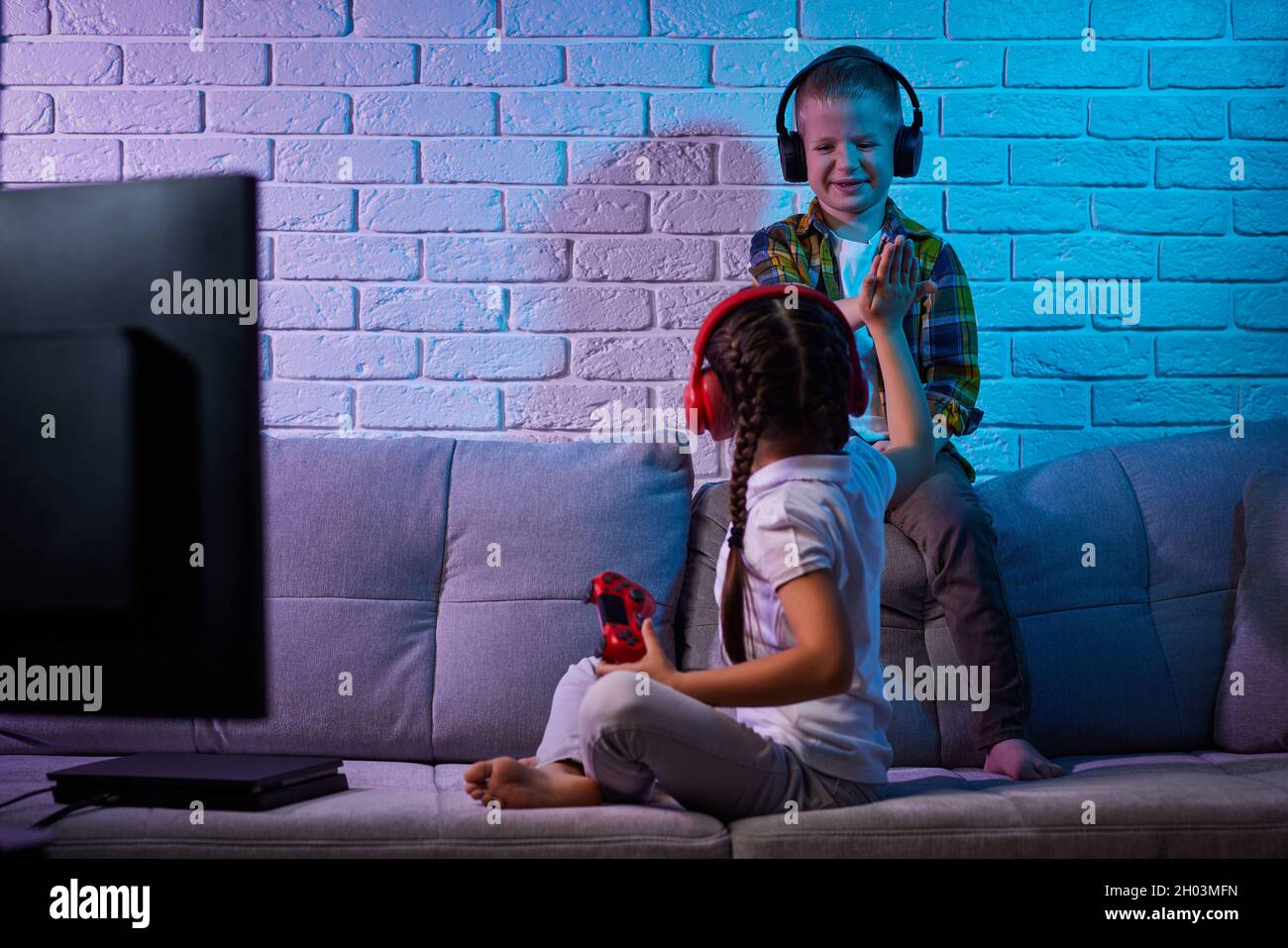 children playing video game with game console Stock Photo - Alamy