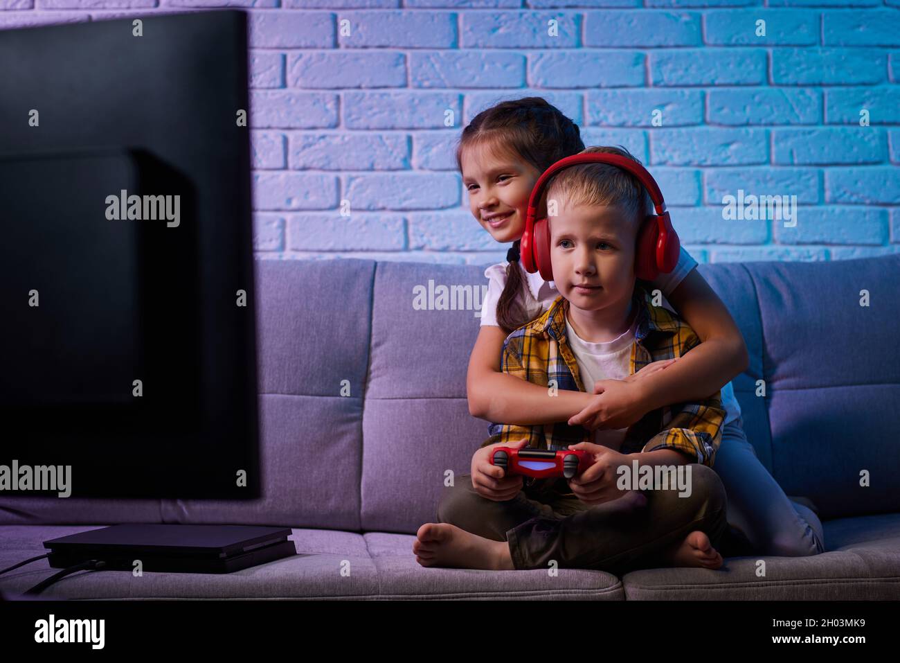 children playing video game with game console Stock Photo - Alamy