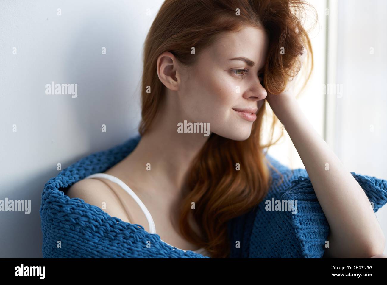 pretty woman sitting near the window with a blue plaid morning Stock ...