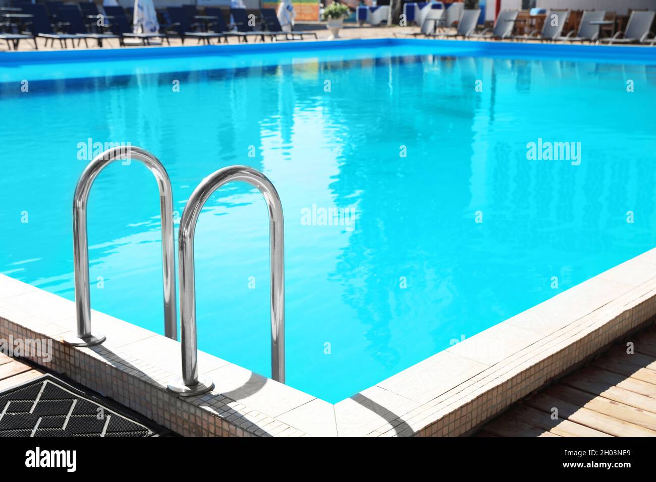 Modern swimming pool with step ladder outdoors Stock Photo - Alamy