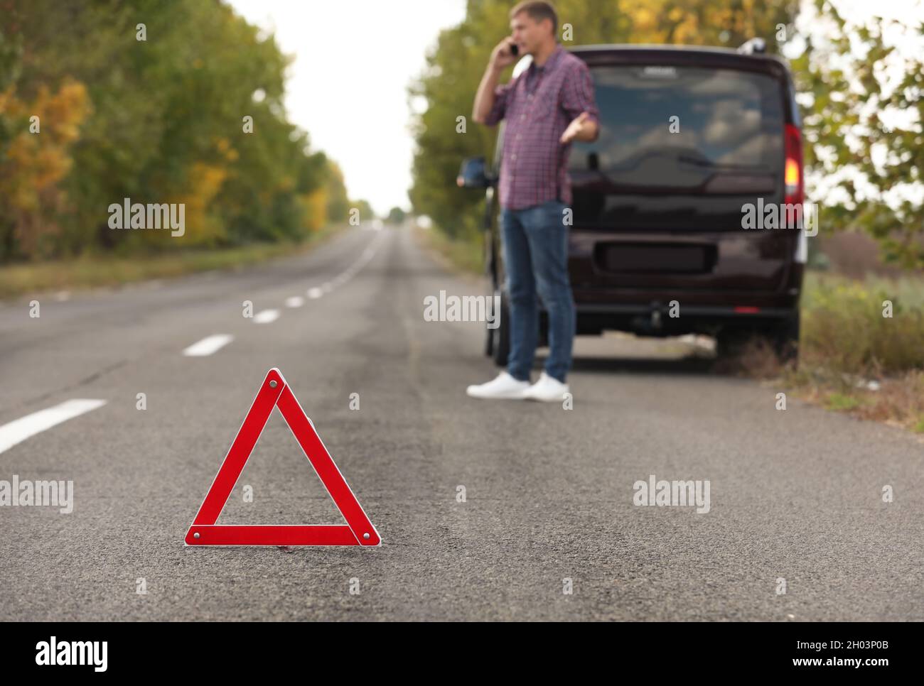 Emergency stop sign and driver near broken car on road. Auto insurance ...