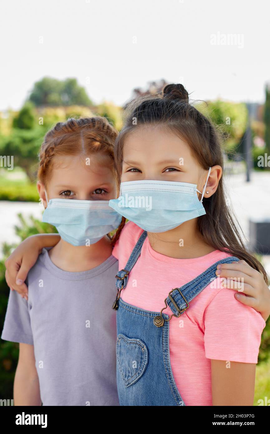 Little child girls friends in protection mask outdoor Stock Photo - Alamy