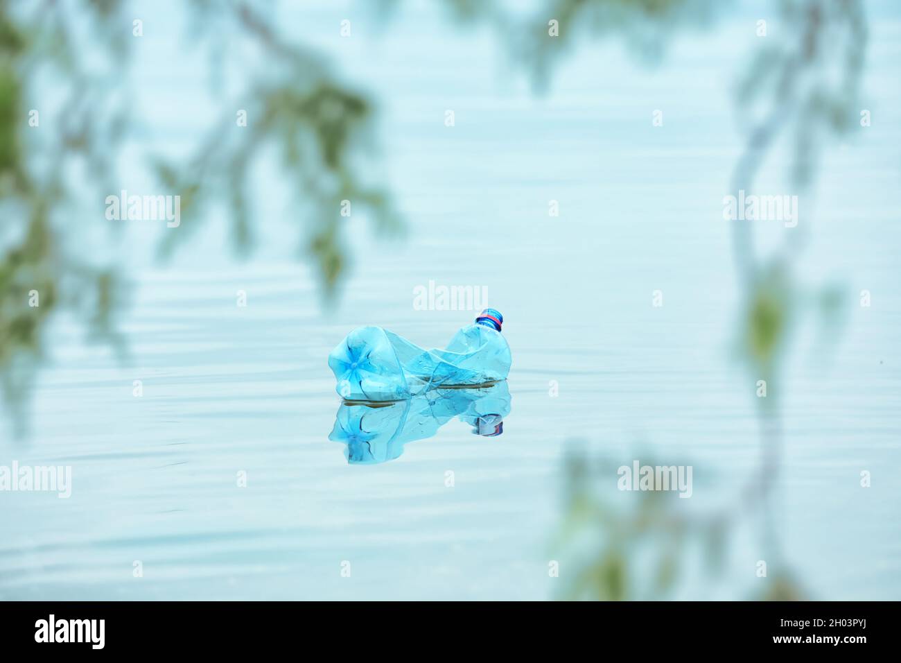 Used plastic bottle floating on water surface. Recycling problem Stock ...
