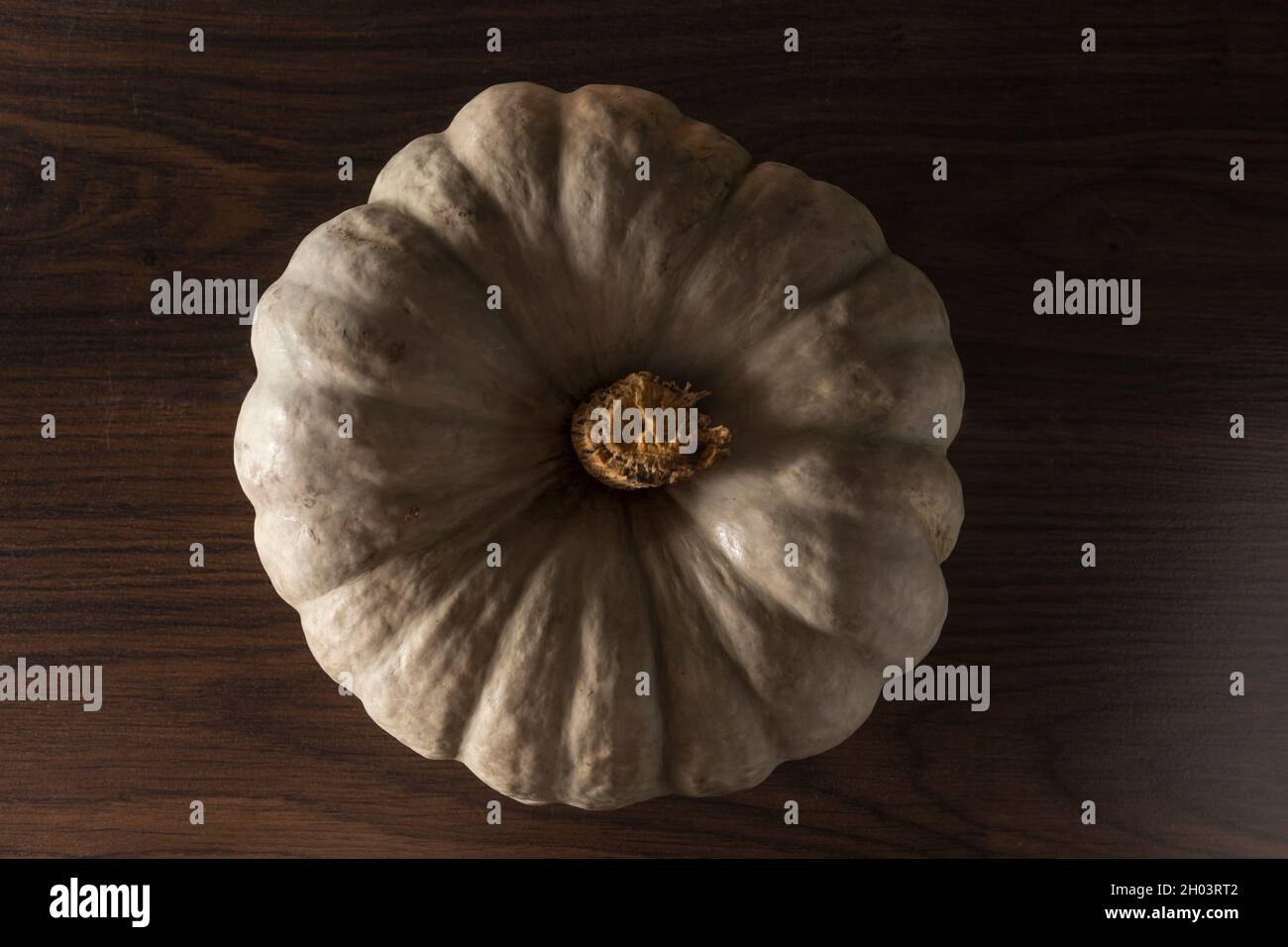 overhead view of a pumpkin placed on a wooden background Stock Photo ...