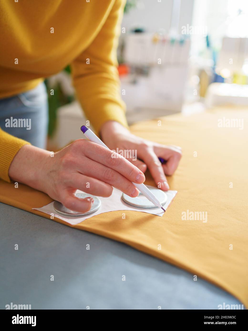 Female seamstress making sewing pattern while working at her creative ...