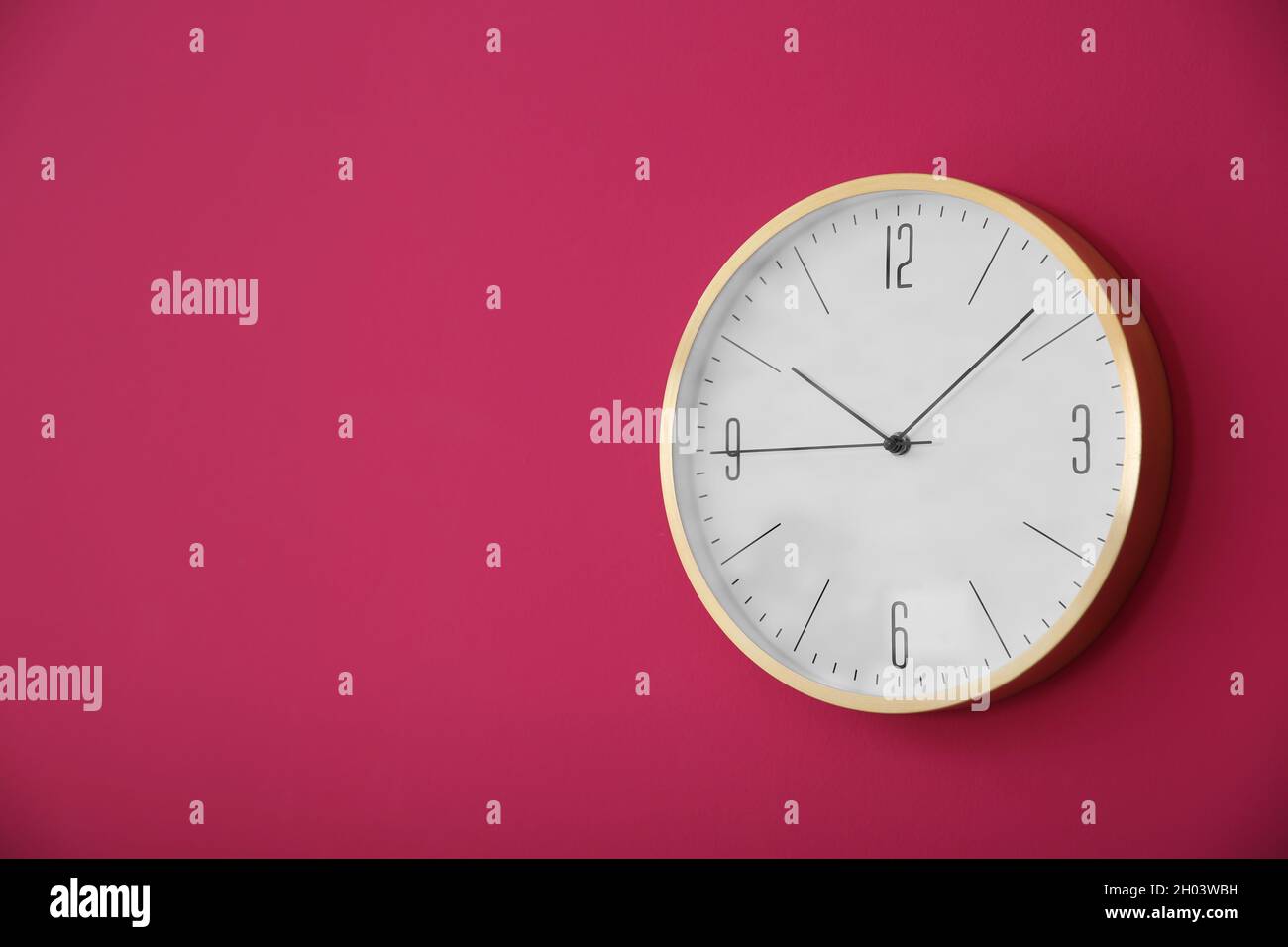 Stylish clock on color wall. Time concept Stock Photo - Alamy