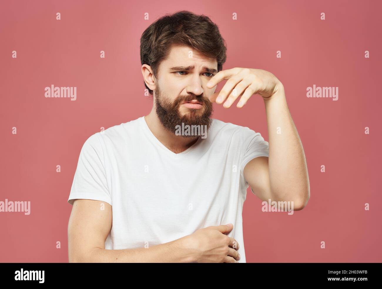 emotional man in a white t-shirt irritated facial expression Studio ...