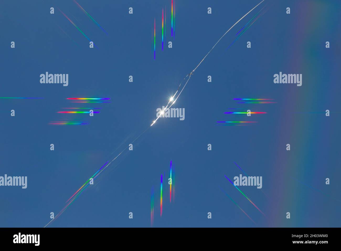 Abstract rainbow lens flare effect on a crack in the window, cross ...