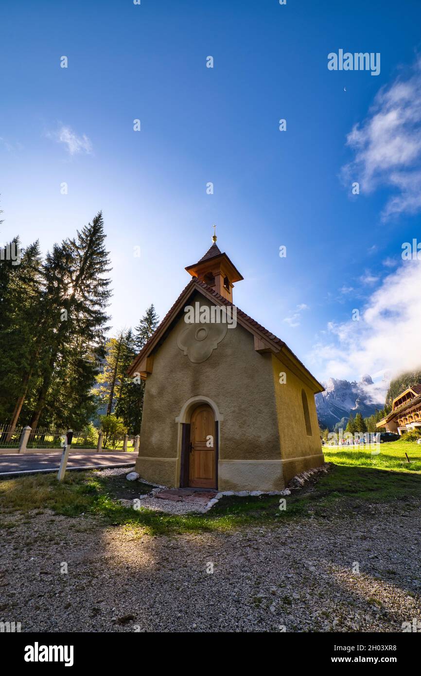 Vertical shot of beautiful scenery of the Dolomites and a chapel in the ...