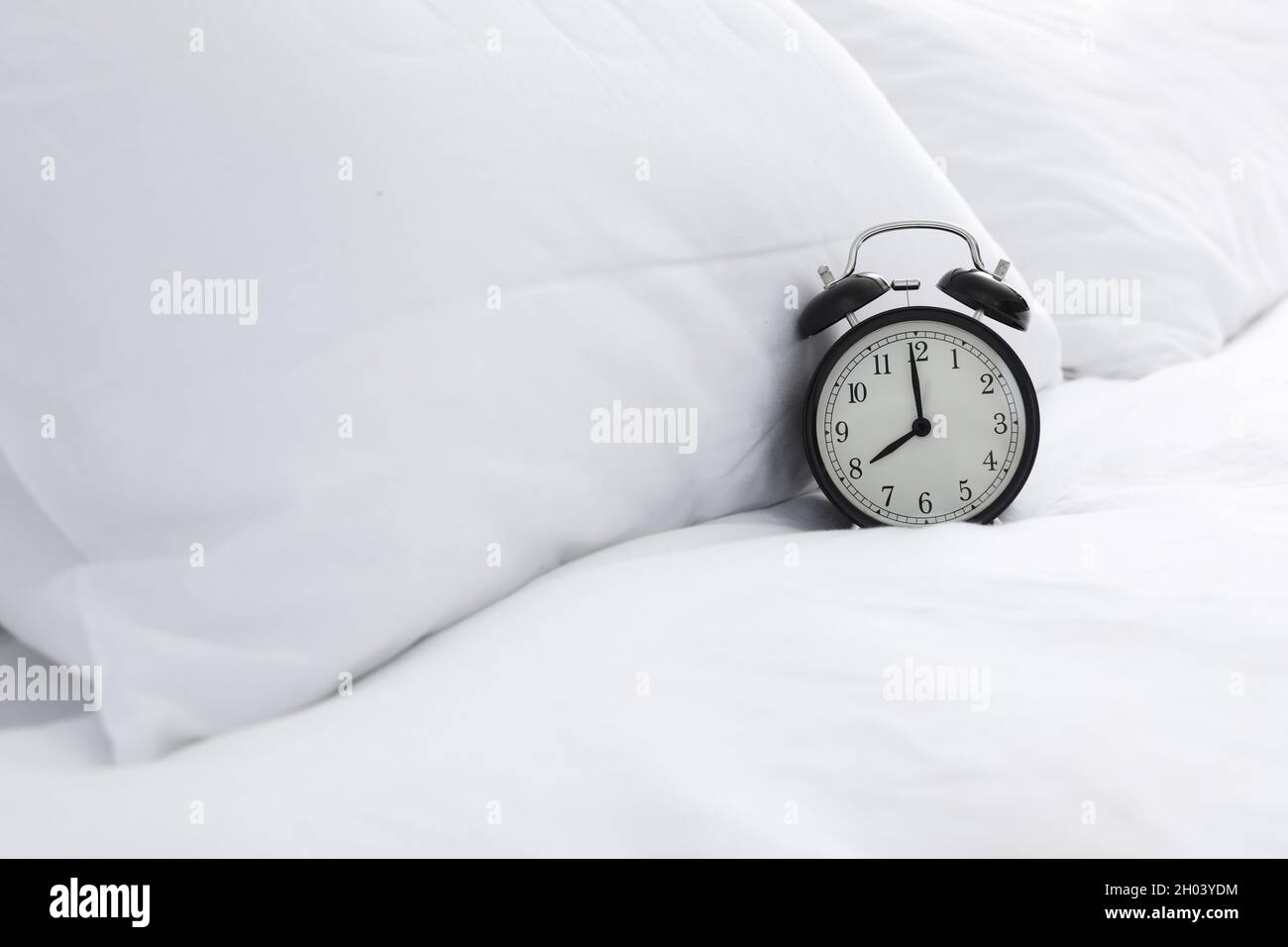 Alarm clock on bed. Time to wake up Stock Photo - Alamy