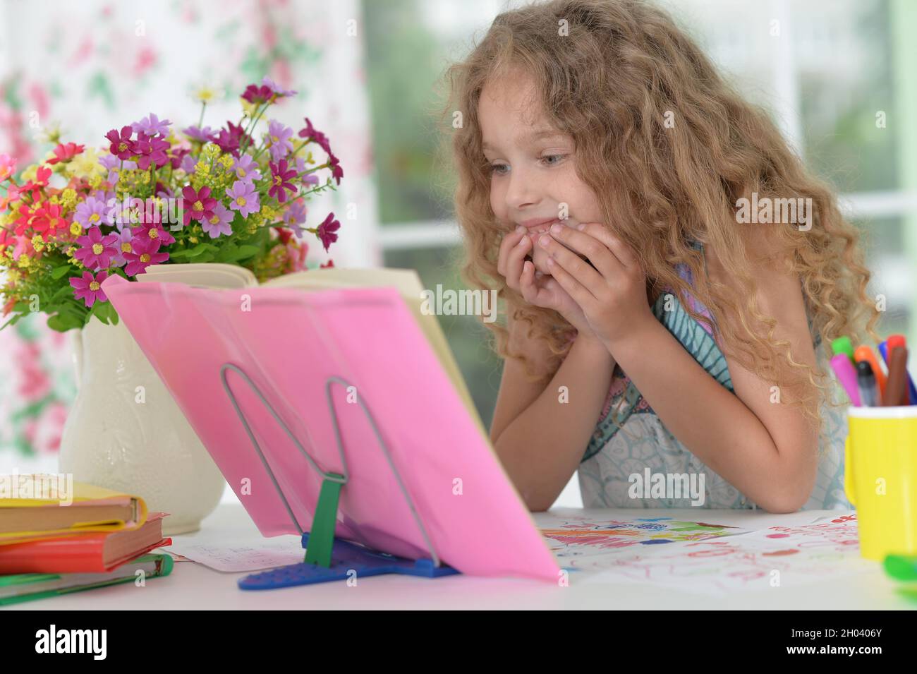 Cute girl doing home work at desk Stock Photo - Alamy