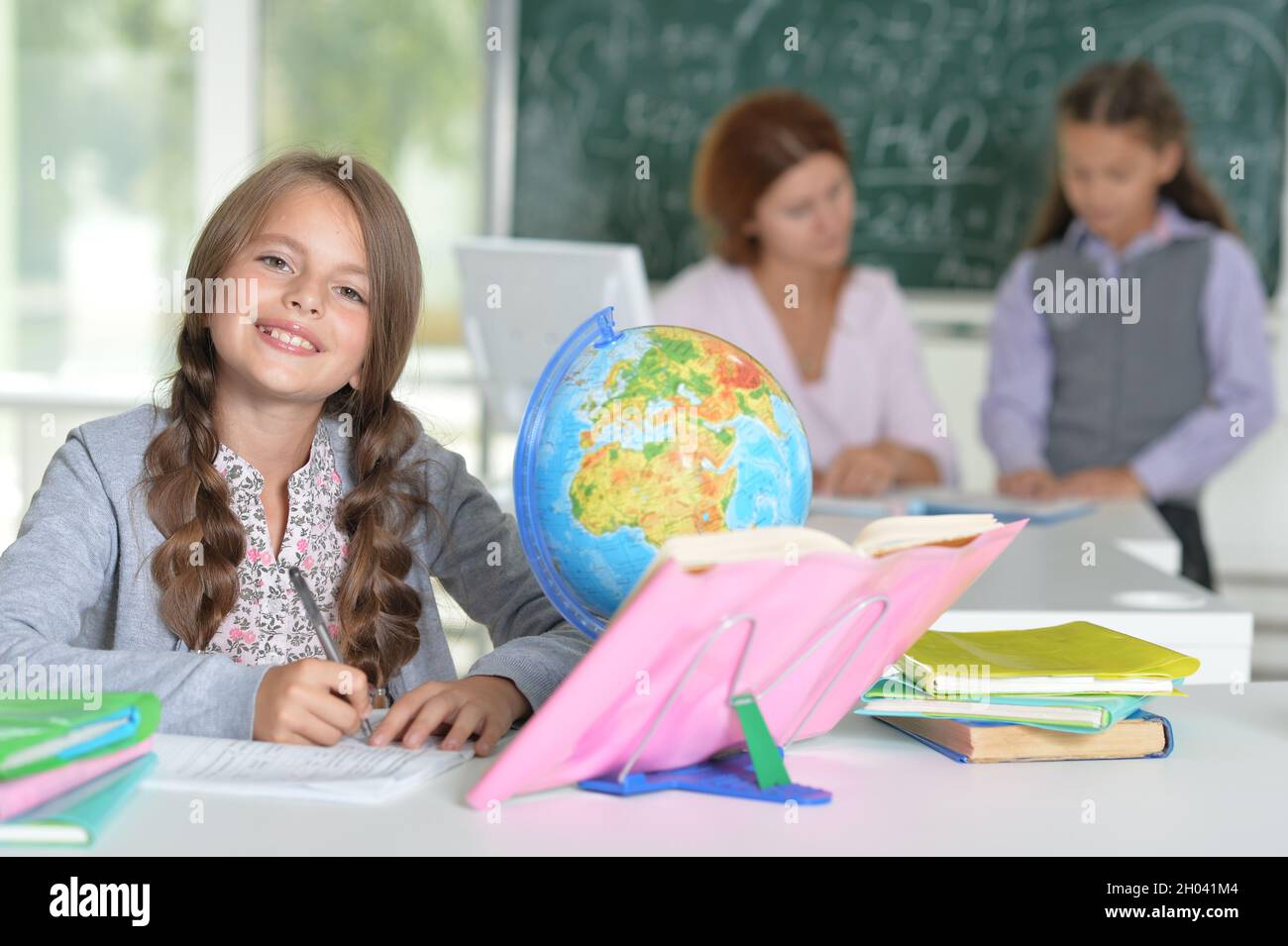 Cute girl studying in the class room Stock Photo - Alamy
