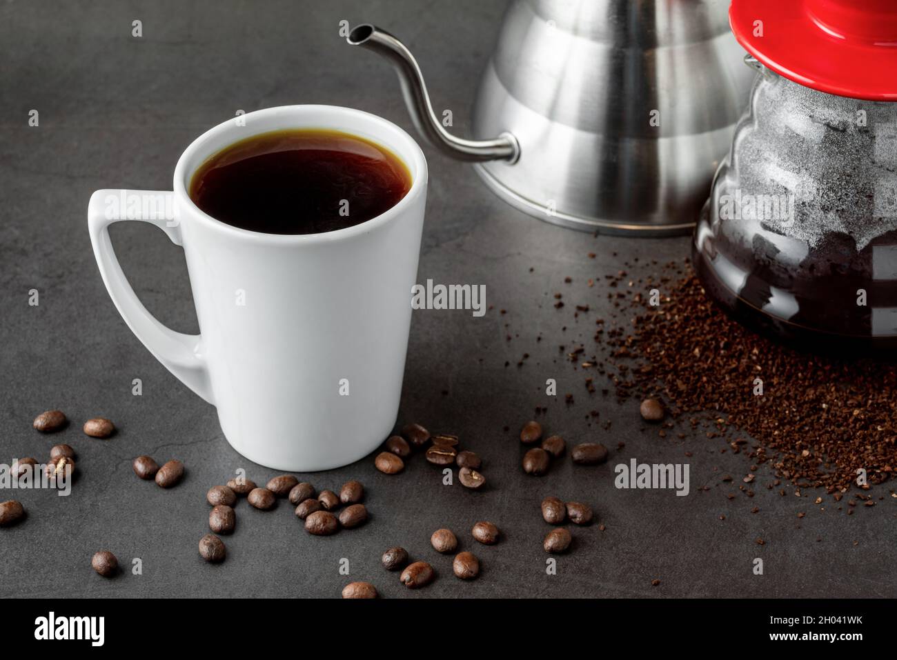 A cup of coffee and third generation pour over coffee brewing equipment ...