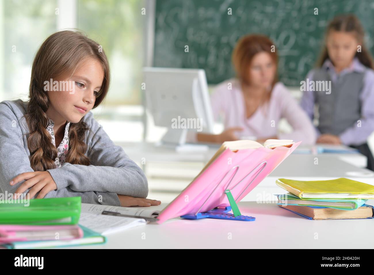 Cute girl studying in the class room Stock Photo - Alamy