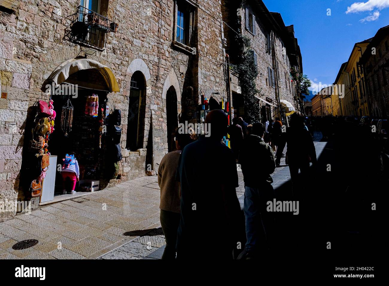 general view of the historic centre of assisi, tourists crowd the ...