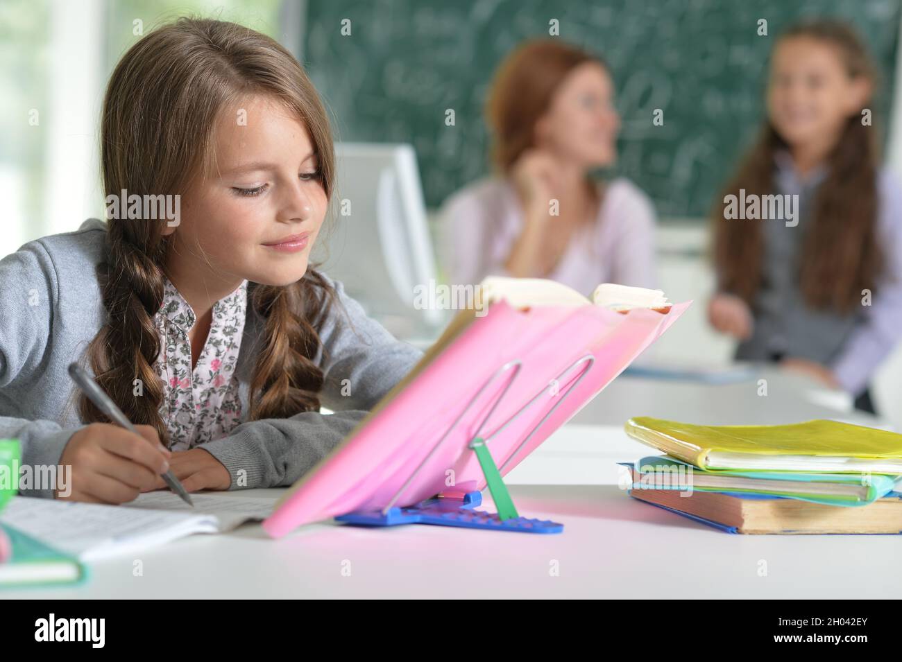 Cute girl studying in the class room Stock Photo - Alamy