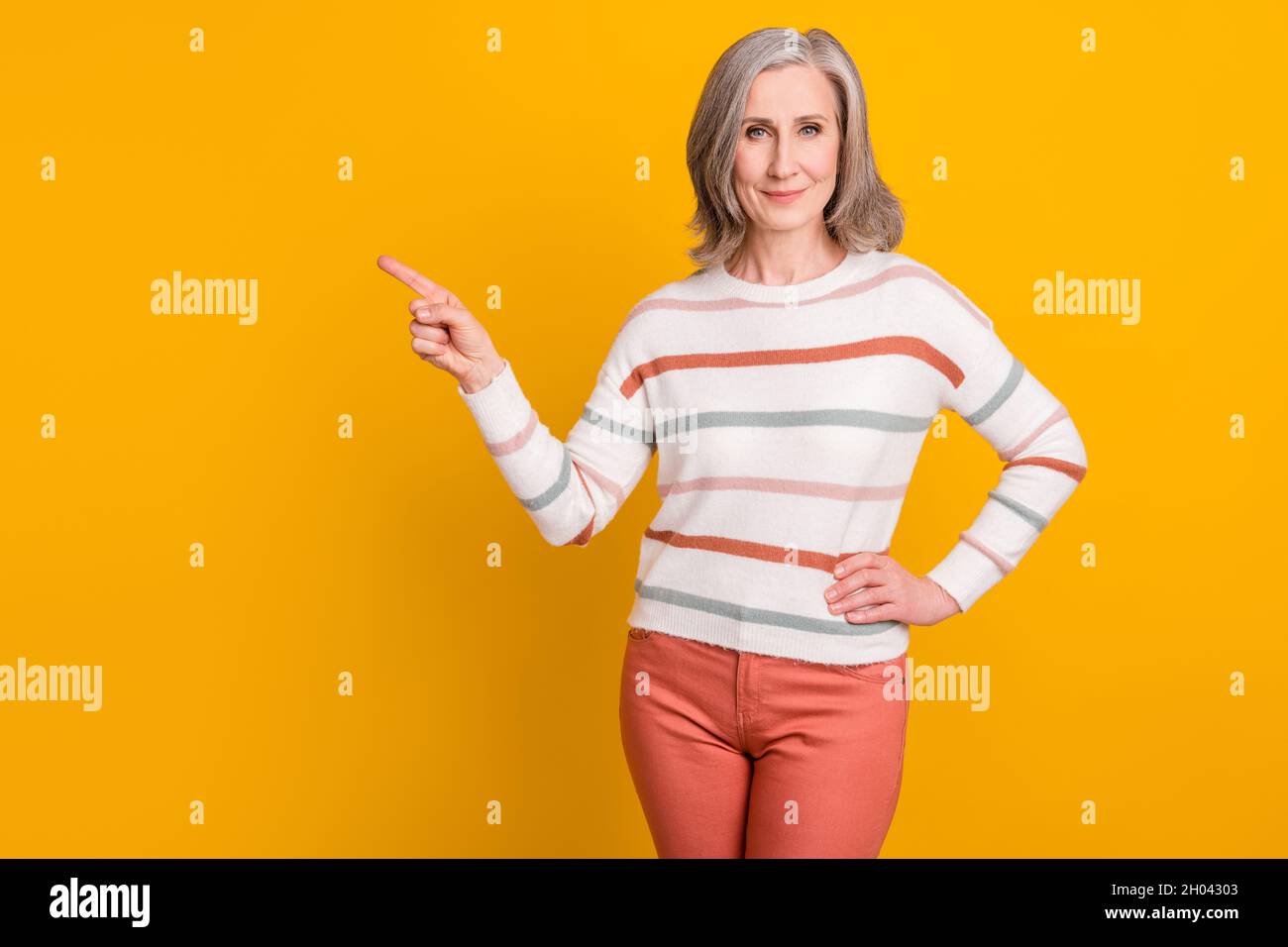 Photo of pretty adorable lady pensioner wear striped pullover pointing ...