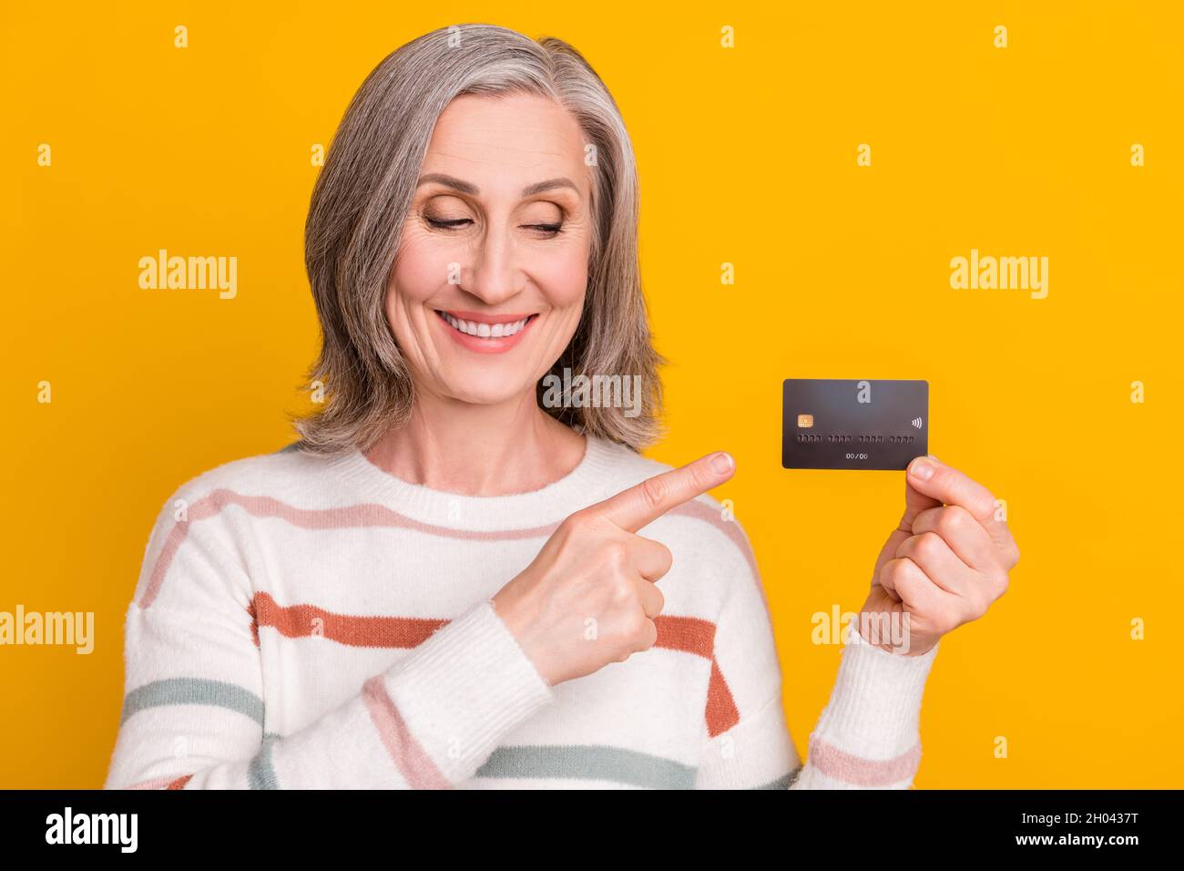 Photo of pretty sweet lady pensioner wear striped pullover looking ...