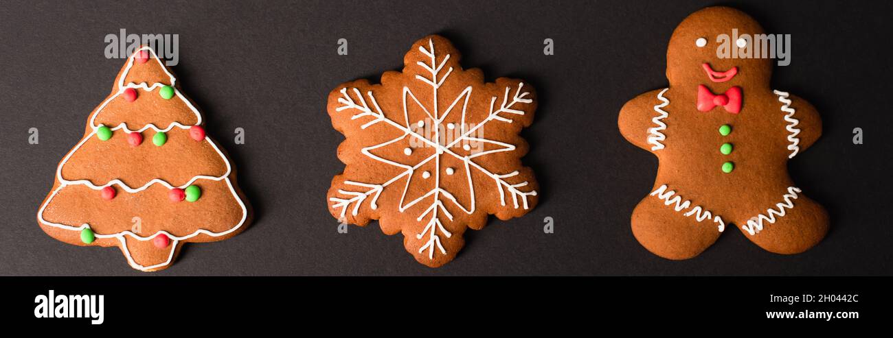 top view of different shapes gingerbread cookies on black, banner Stock ...