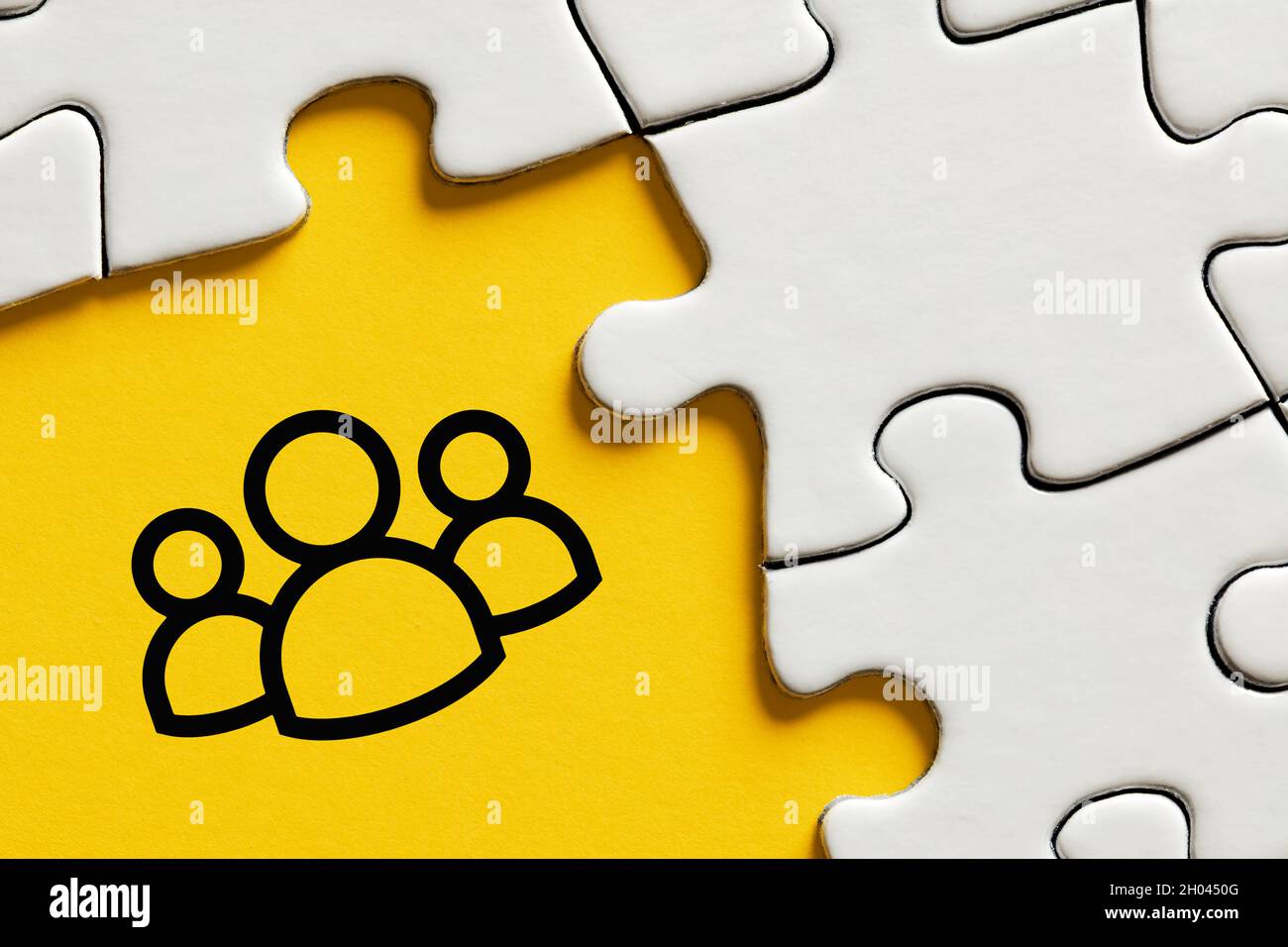 Team or teamwork symbol on yellow background surrounded by puzzle ...