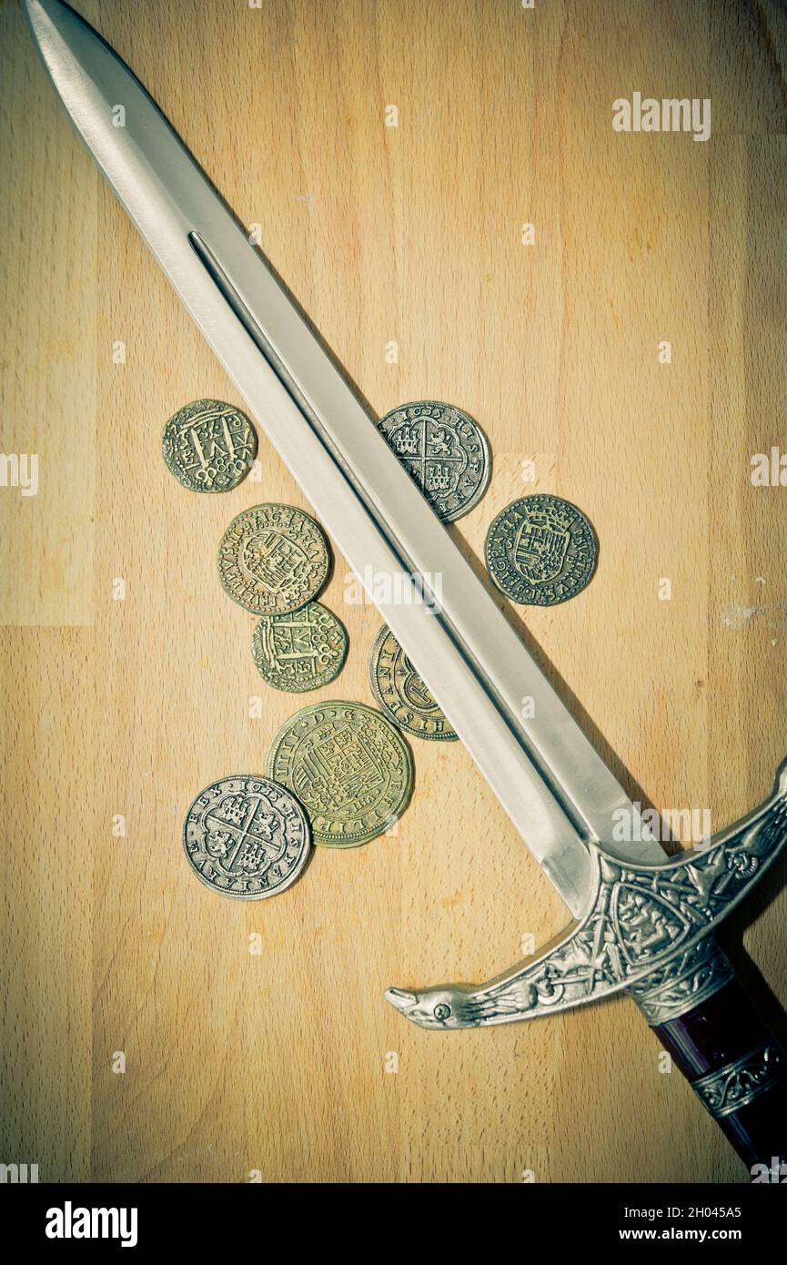medieval sword and coins Stock Photo - Alamy