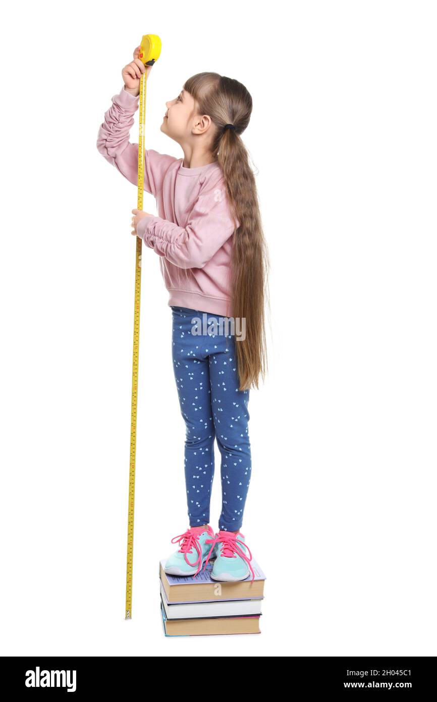Little girl measuring her height on white background Stock Photo - Alamy