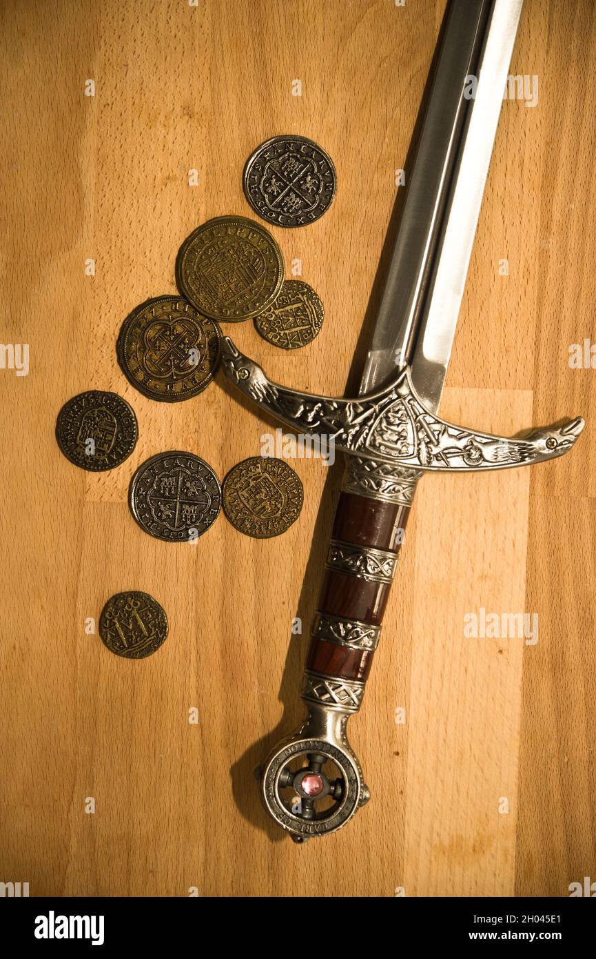 medieval sword and coins Stock Photo - Alamy