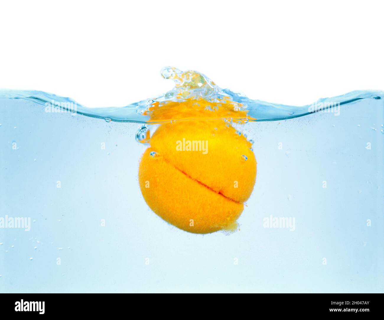 Bath bomb splashing into water on white background Stock Photo - Alamy