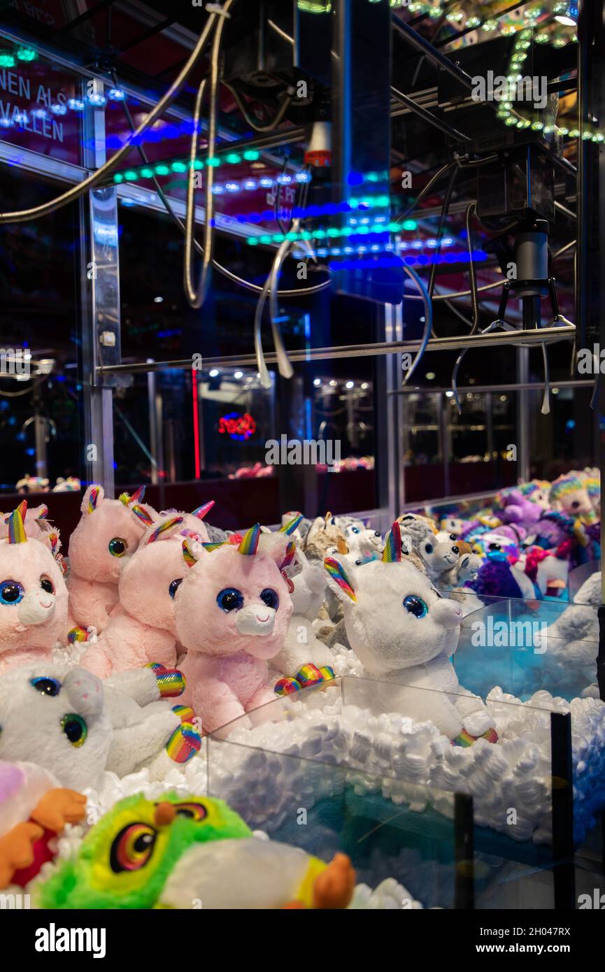Claw machine Toy Arcade game filled with unicorns childrens toys Stock ...