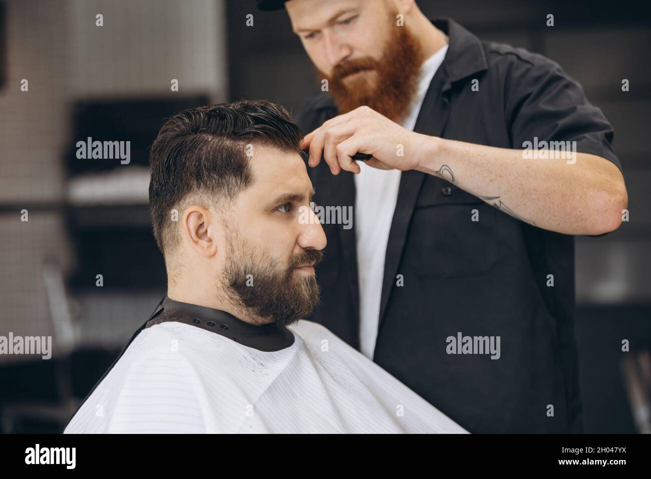 Professional barber at work process. Beauty, selfcare, style, fashion ...