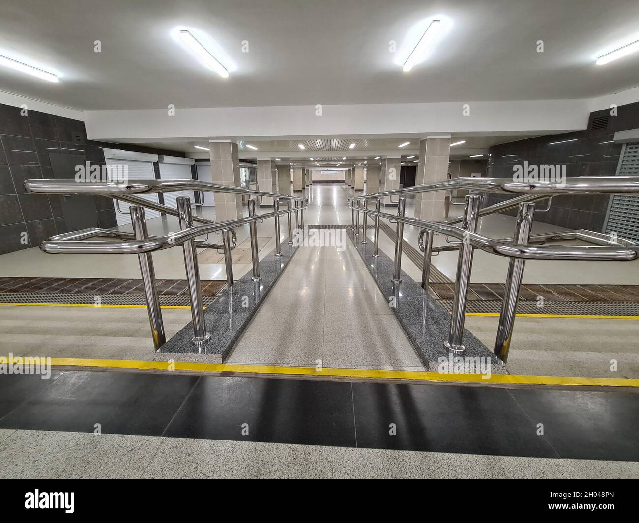 Handicapped ramp with metal railings in underpass background Stock ...