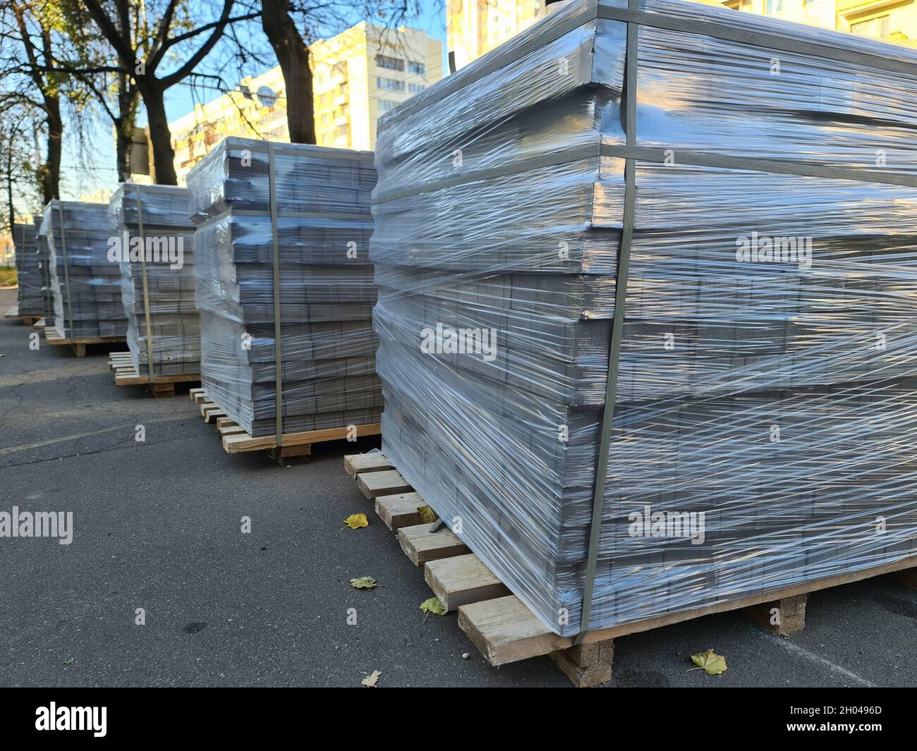 Paving slabs in plastic wrap lying on wooden pallet in street Stock ...