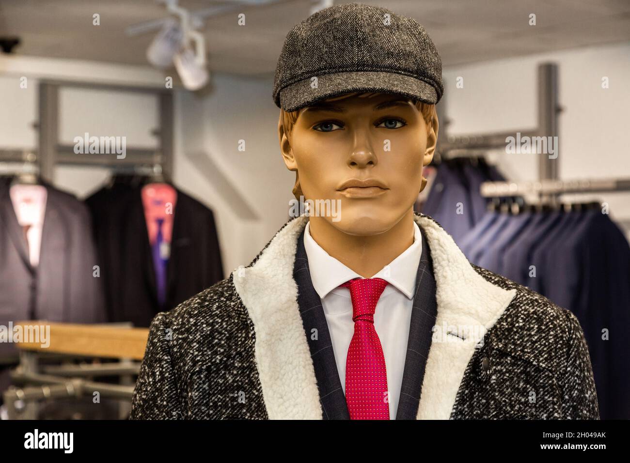 Male mannequin dressed in autumn clothes, classic suit with a red tie ...