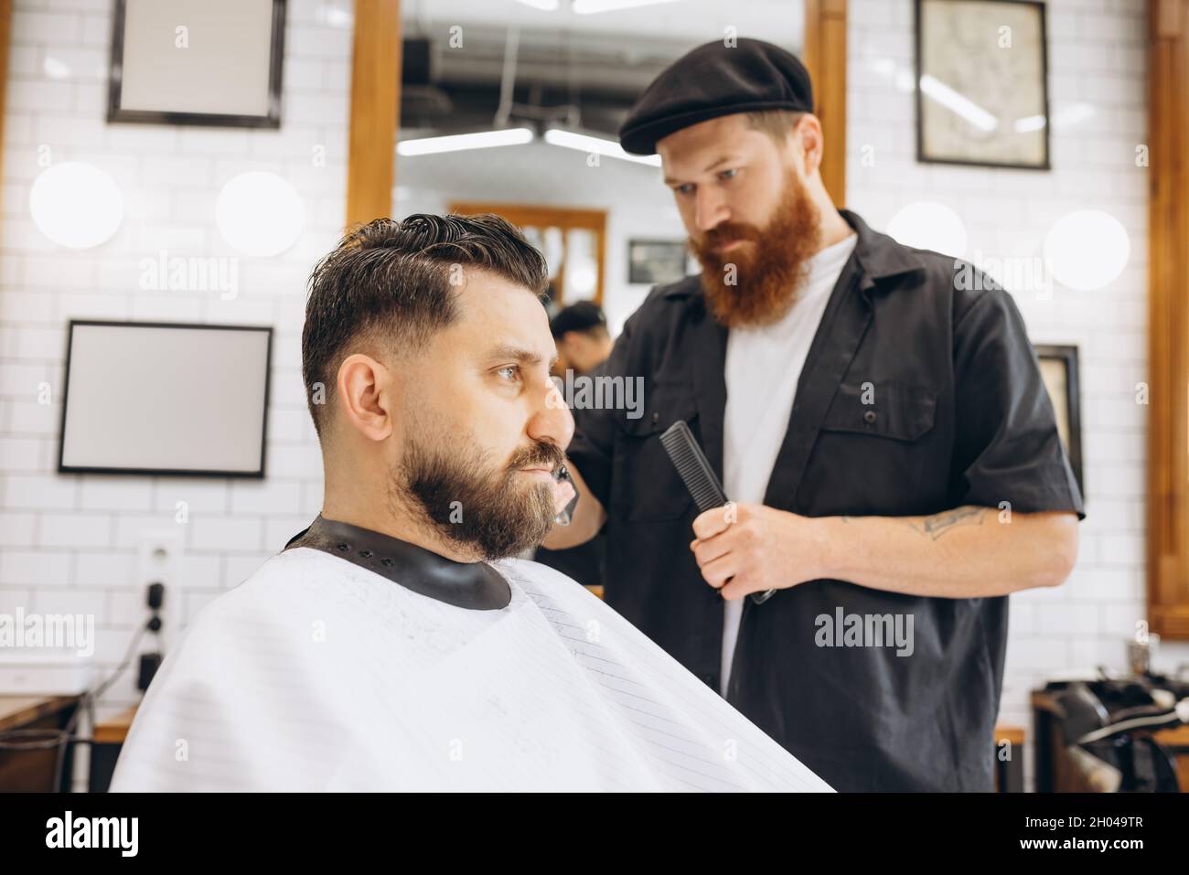 Man getting haircut at the barbershop. Professional barber at work ...