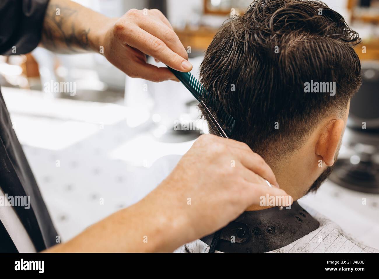 Professional barber at work process. Beauty, selfcare, style, fashion ...