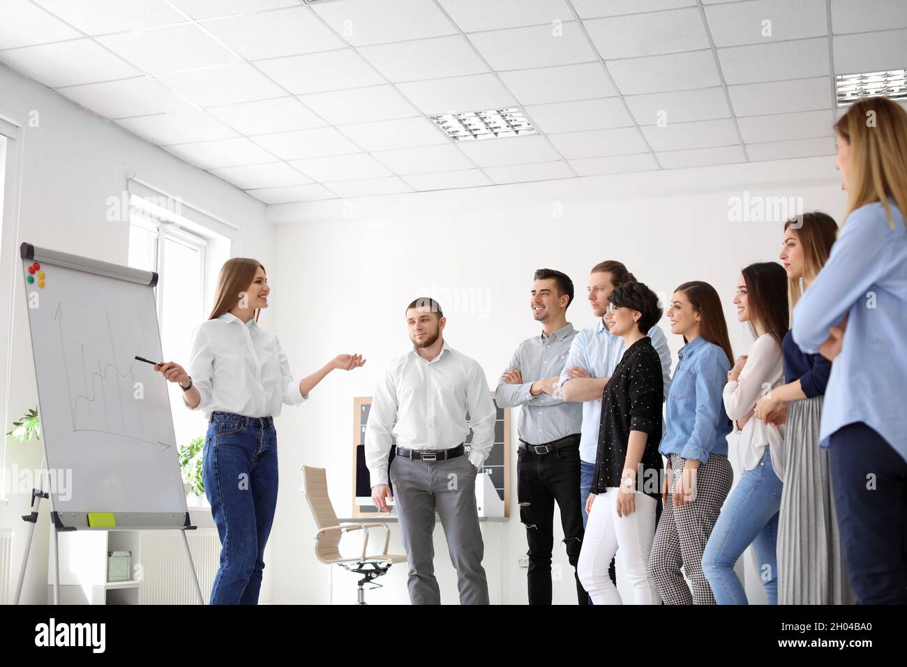 Female business trainer giving lecture in office Stock Photo - Alamy