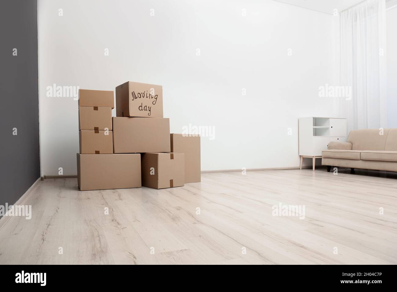 Pile of moving boxes in empty room Stock Photo - Alamy