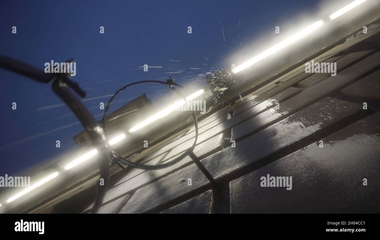 Bottom view of the building wall and a drainpipe during heavy rain on ...