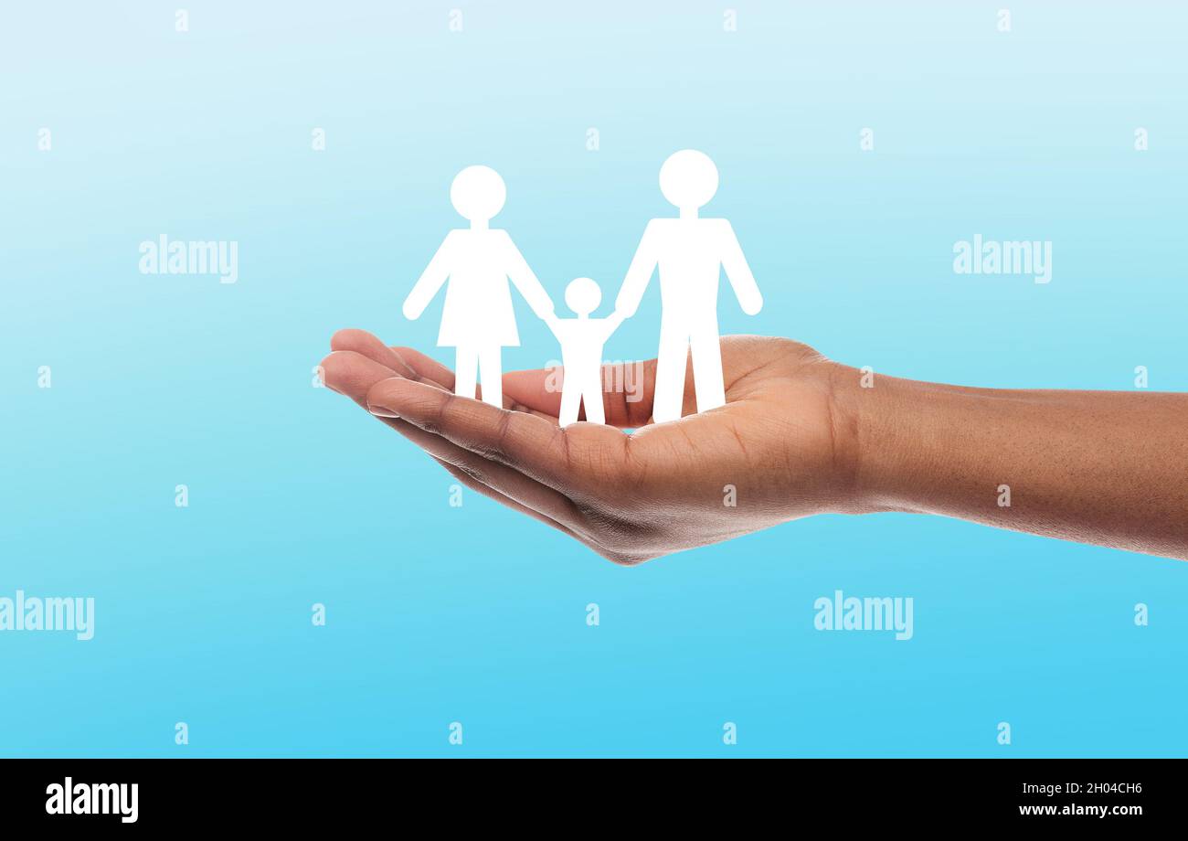 Male mixed race hand holds silhouette of people, mother, father and ...