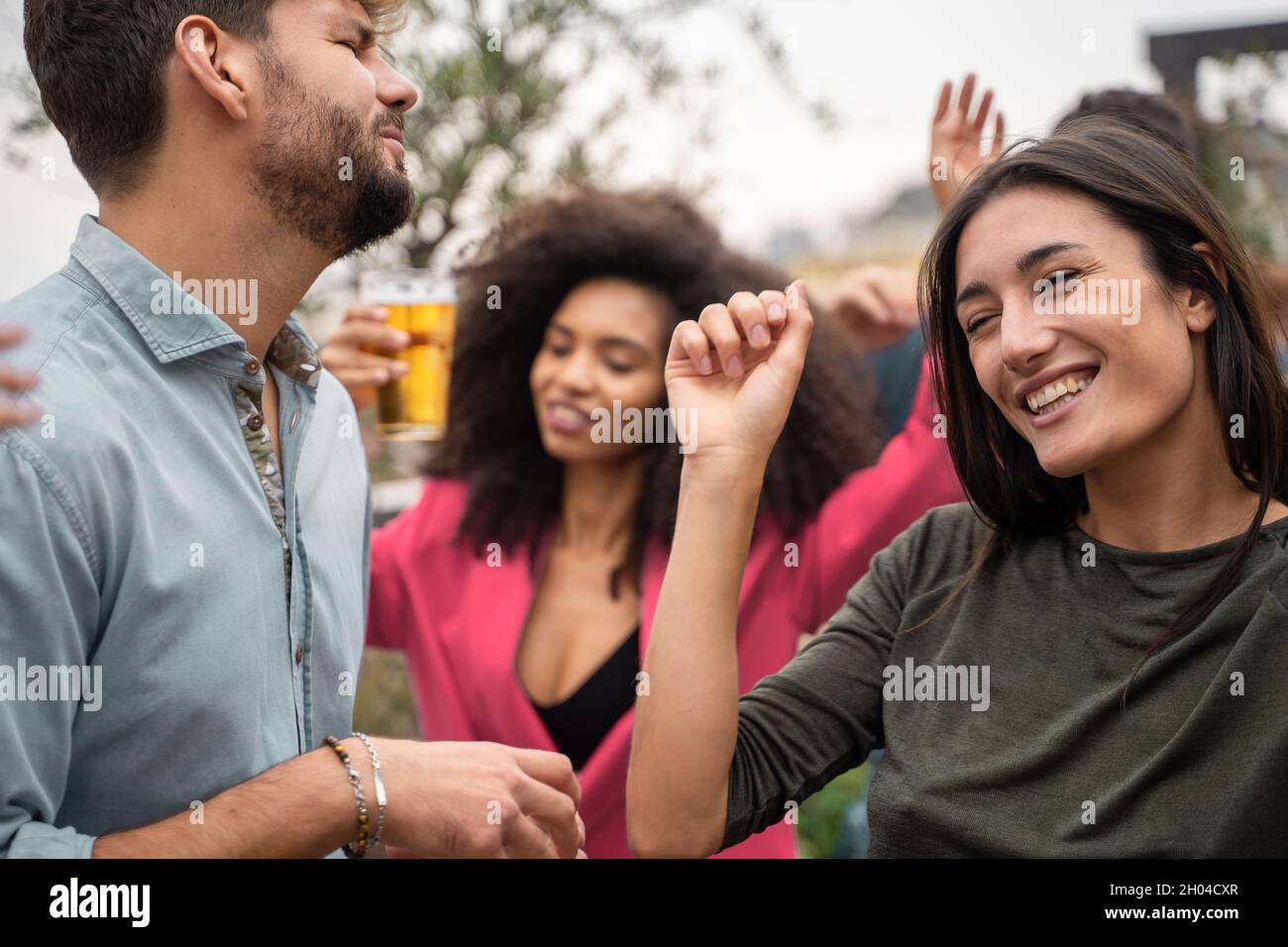 Group of friends having fun dancing together on the rooftop Stock Photo ...